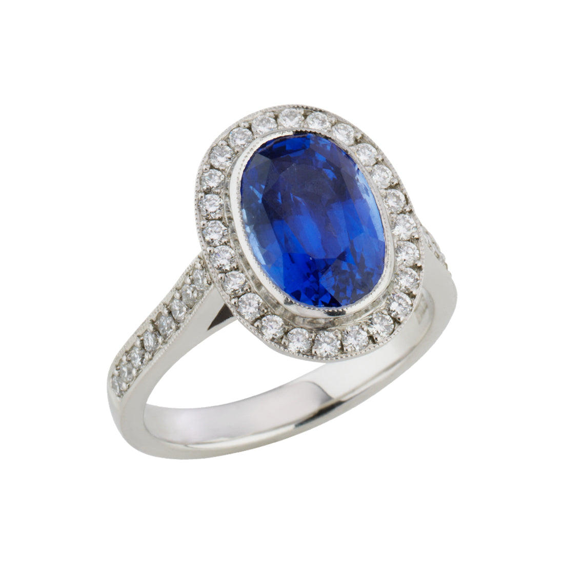 Platinum Rub Set Oval Cut Sapphire and Round Brilliant Cut Diamond Hal ...